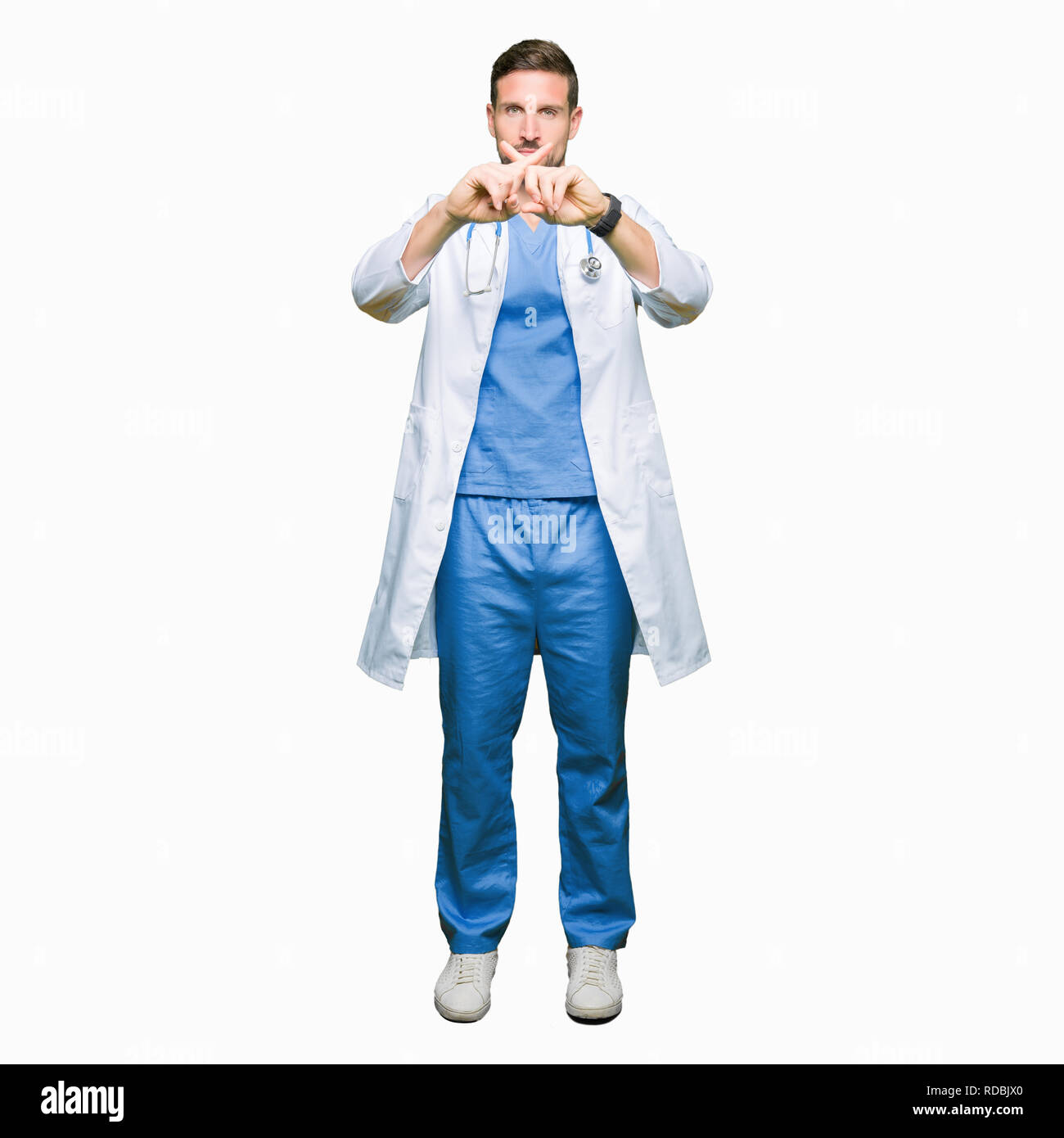 Handsome doctor man wearing medical uniform over isolated background ...