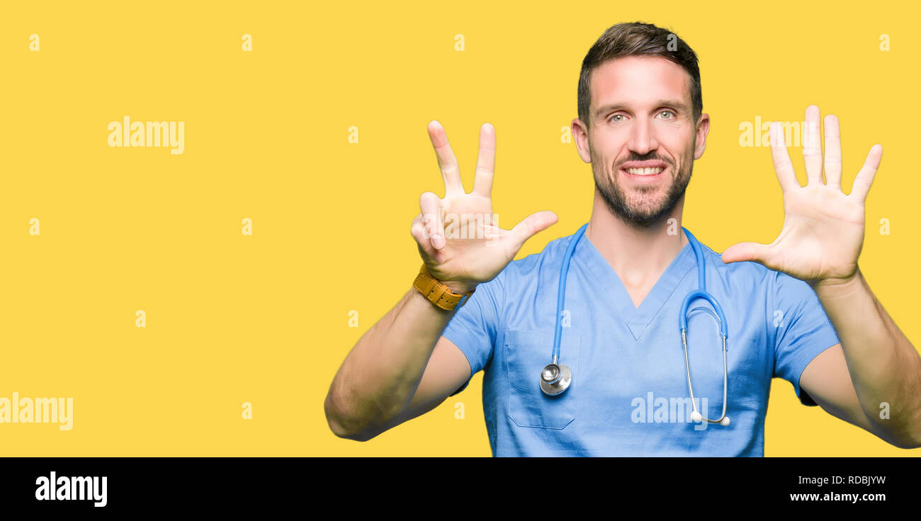 Handsome doctor man wearing medical uniform over isolated background ...