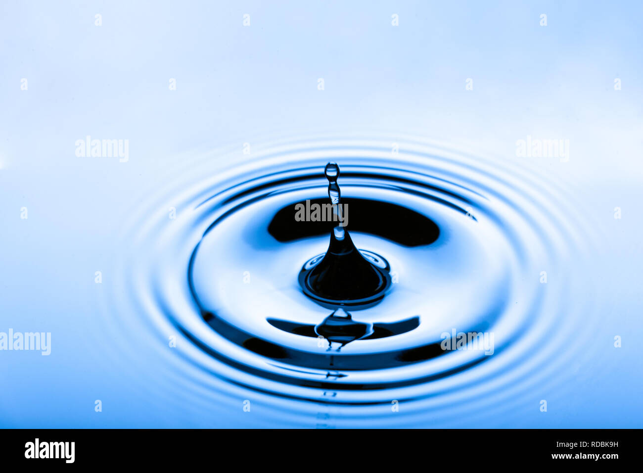 Blue water droplets on a shiny surface Stock Photo - Alamy