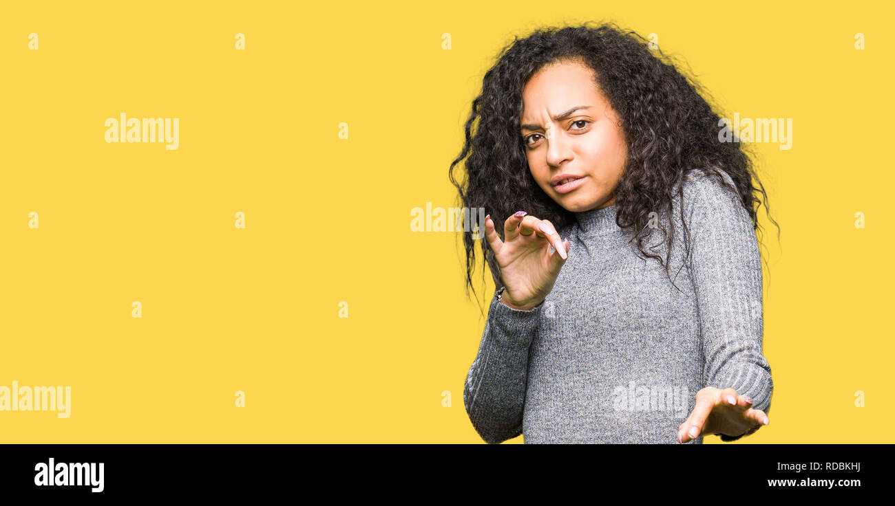 Young beautiful girl with curly hair disgusted expression, displeased ...