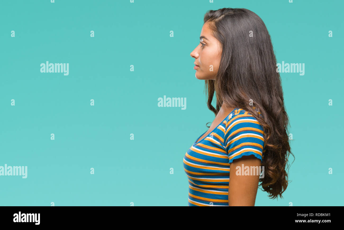 Young beautiful arab woman over isolated background looking to side ...