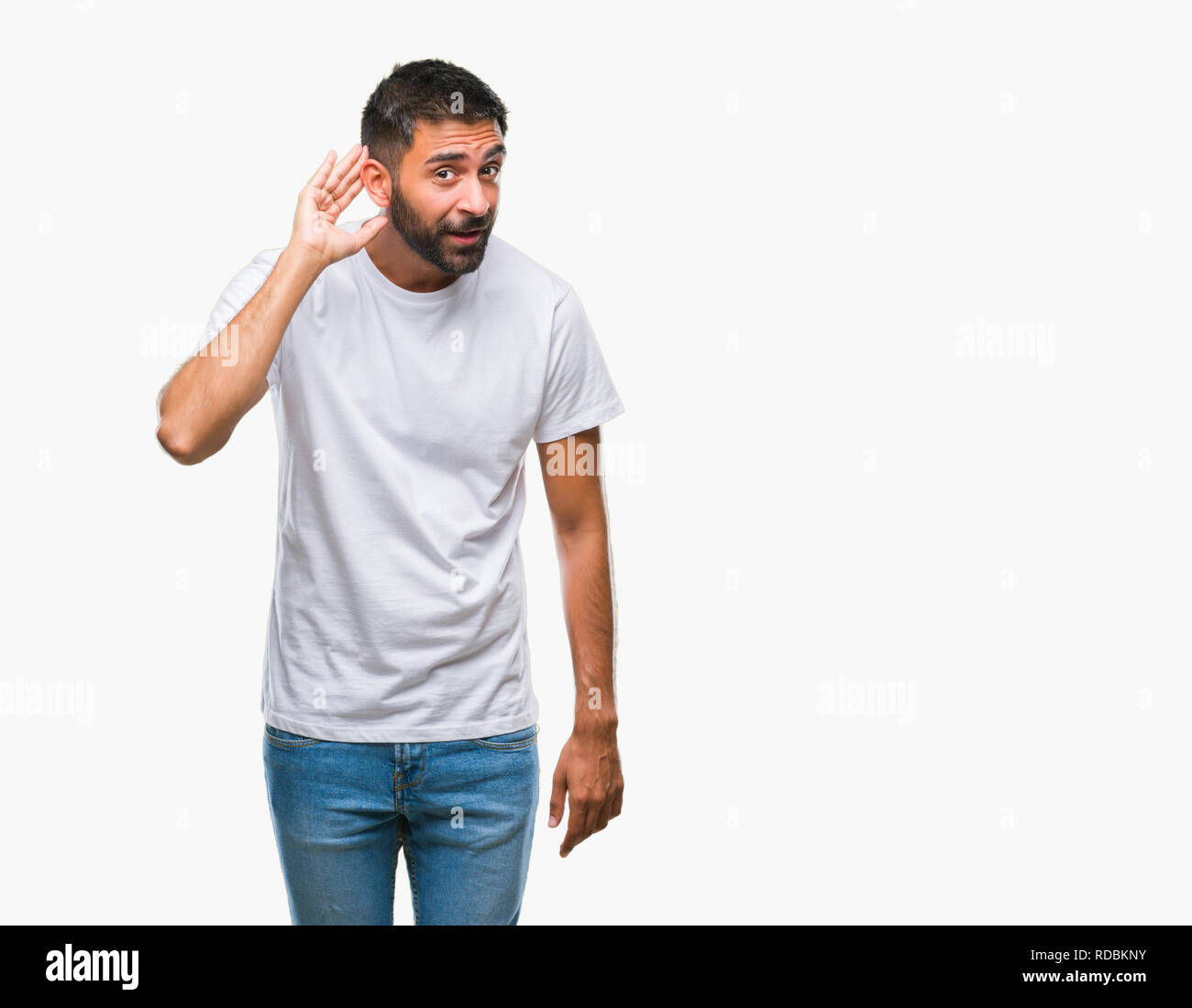 Adult hispanic man over isolated background smiling with hand over ear ...