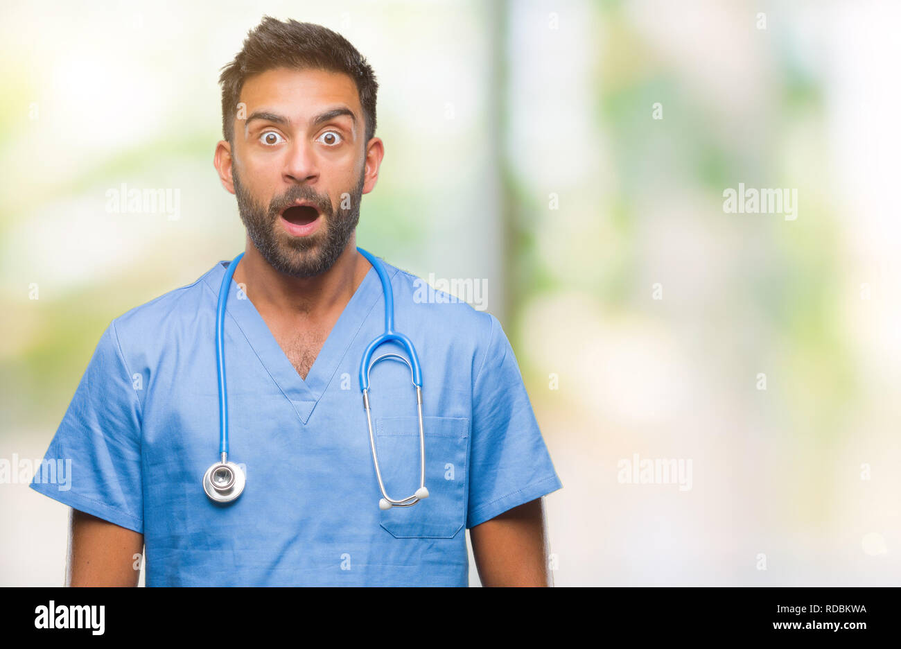 Adult hispanic doctor or surgeon man over isolated background afraid ...