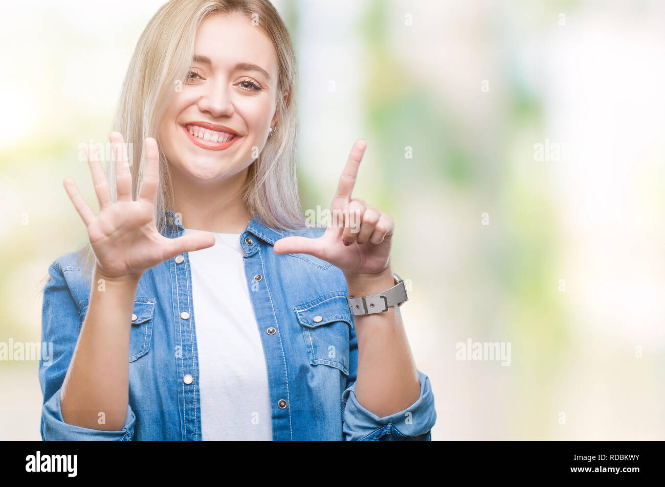 Young blonde woman over isolated background showing and pointing up ...