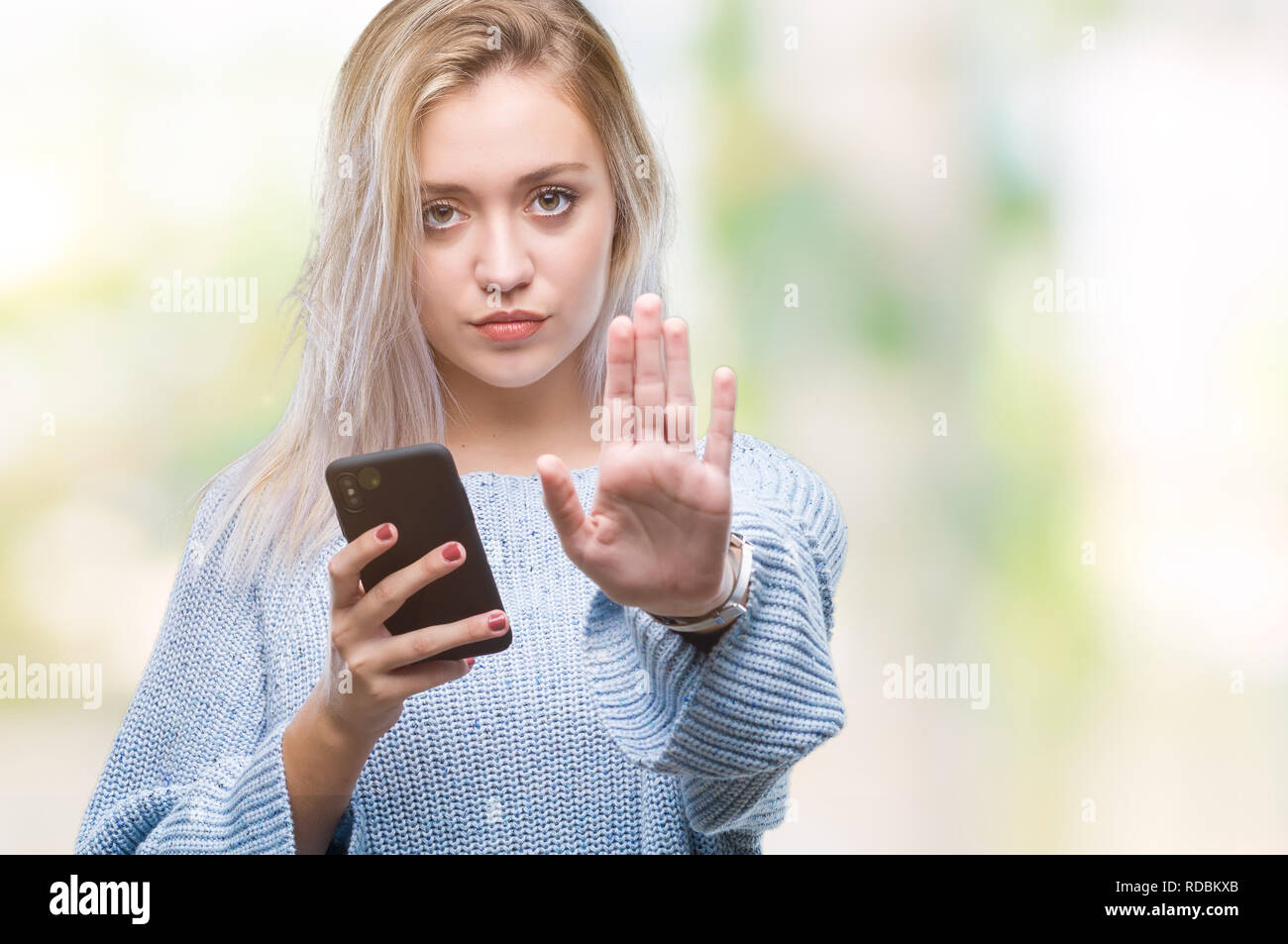 Young blonde woman texting sending message using smartphone over ...