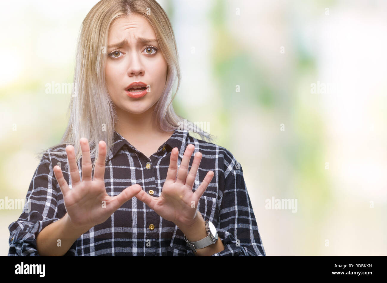 Young blonde woman over isolated background afraid and terrified with ...