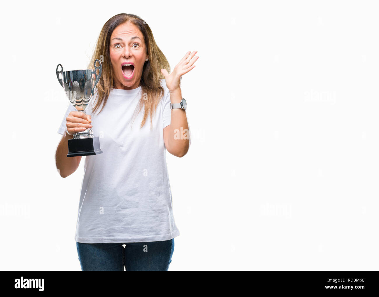 Middle age hispanic winner woman celebrating award holding trophy over ...