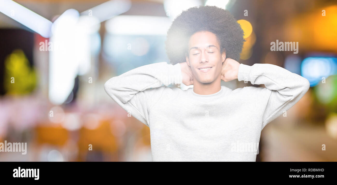 Young african american man with afro hair wearing sporty sweatshirt ...