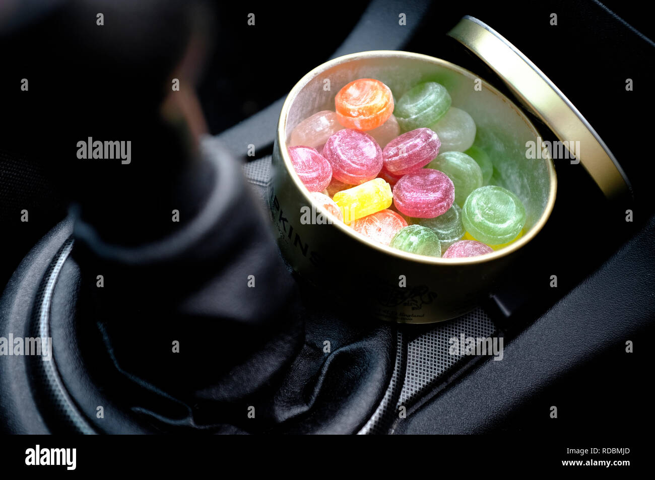 travel sweets in round metal tin on car dashboard Stock Photo - Alamy