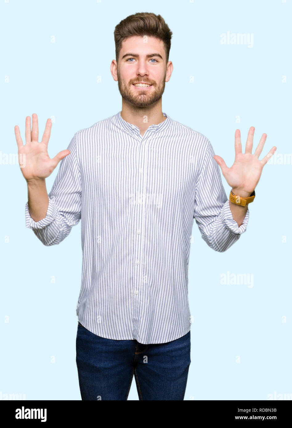 Young handsome man showing and pointing up with fingers number ten ...