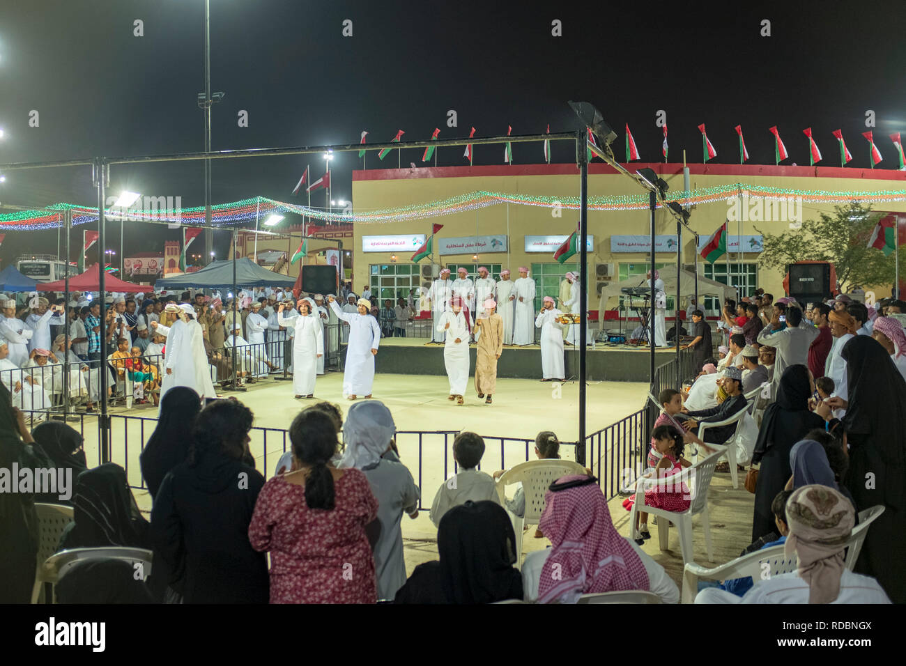 Teenage boys wearing Omani dress - dishdash and turban - performing a ...