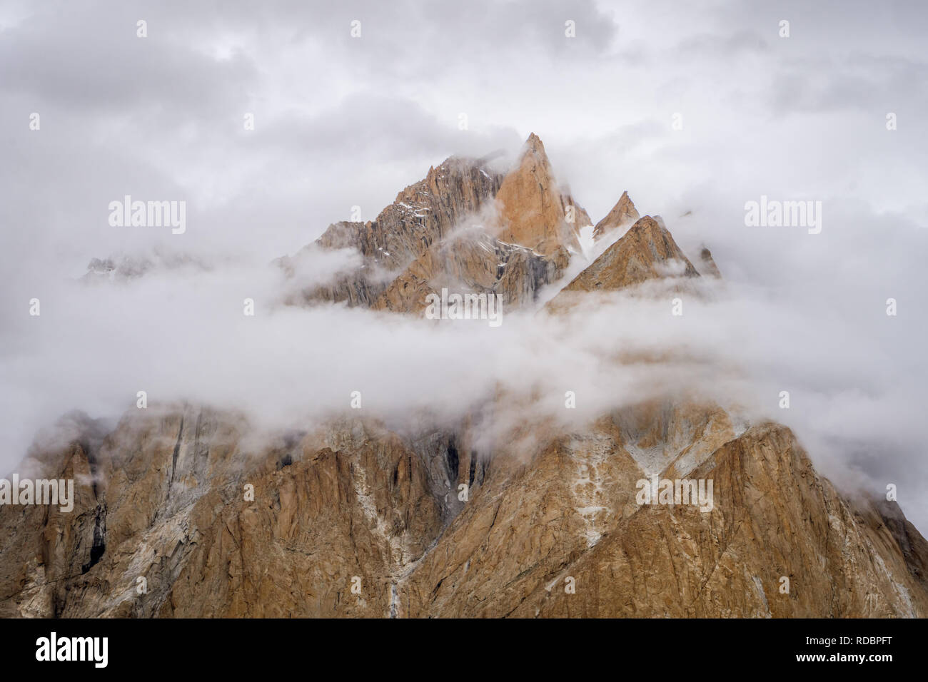 Majestic peak of Trango Towers surrounded by white clouds in Karakoram ...