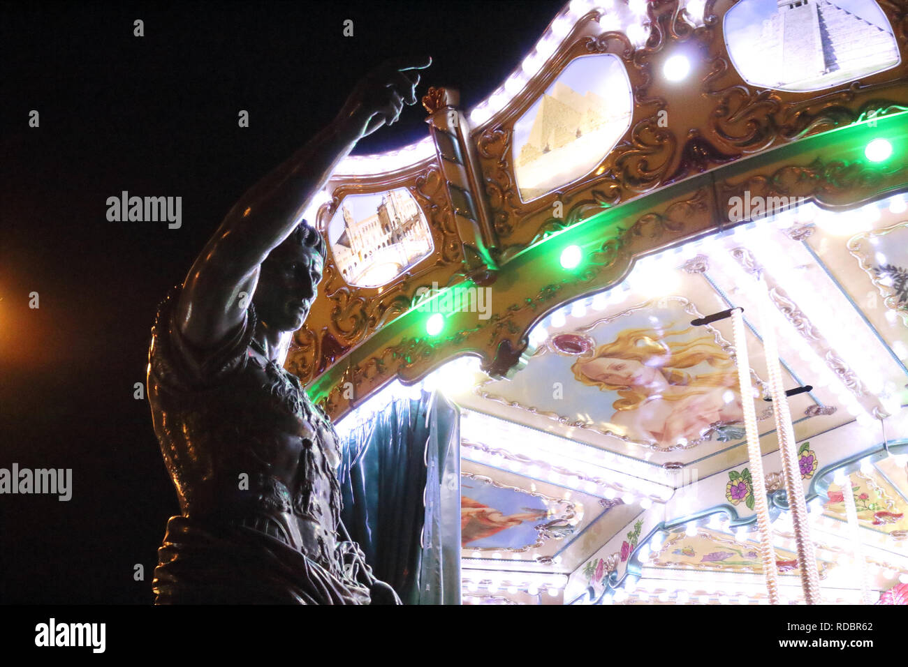 The Cesar August statue in front of carousel, bi night, in Zaragoza ...