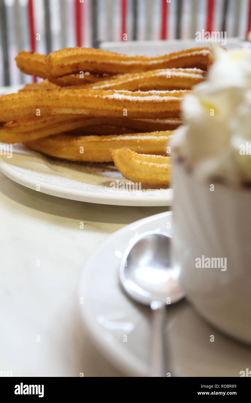 A typical spanish merienda, light meal: a cup of hot chocolate with ...