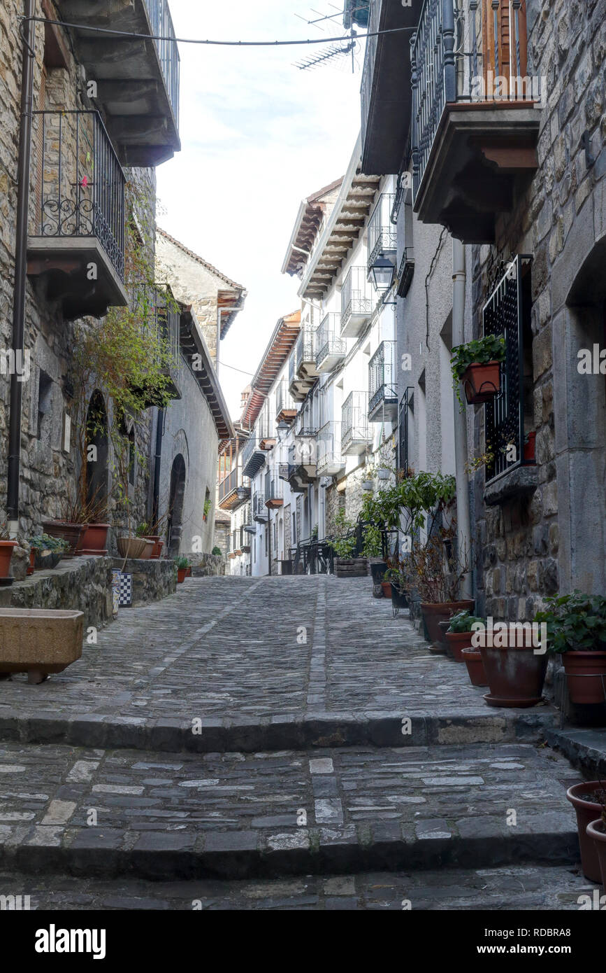 A rural street of a Pyrenees mountain hamlet with stone houses with ...