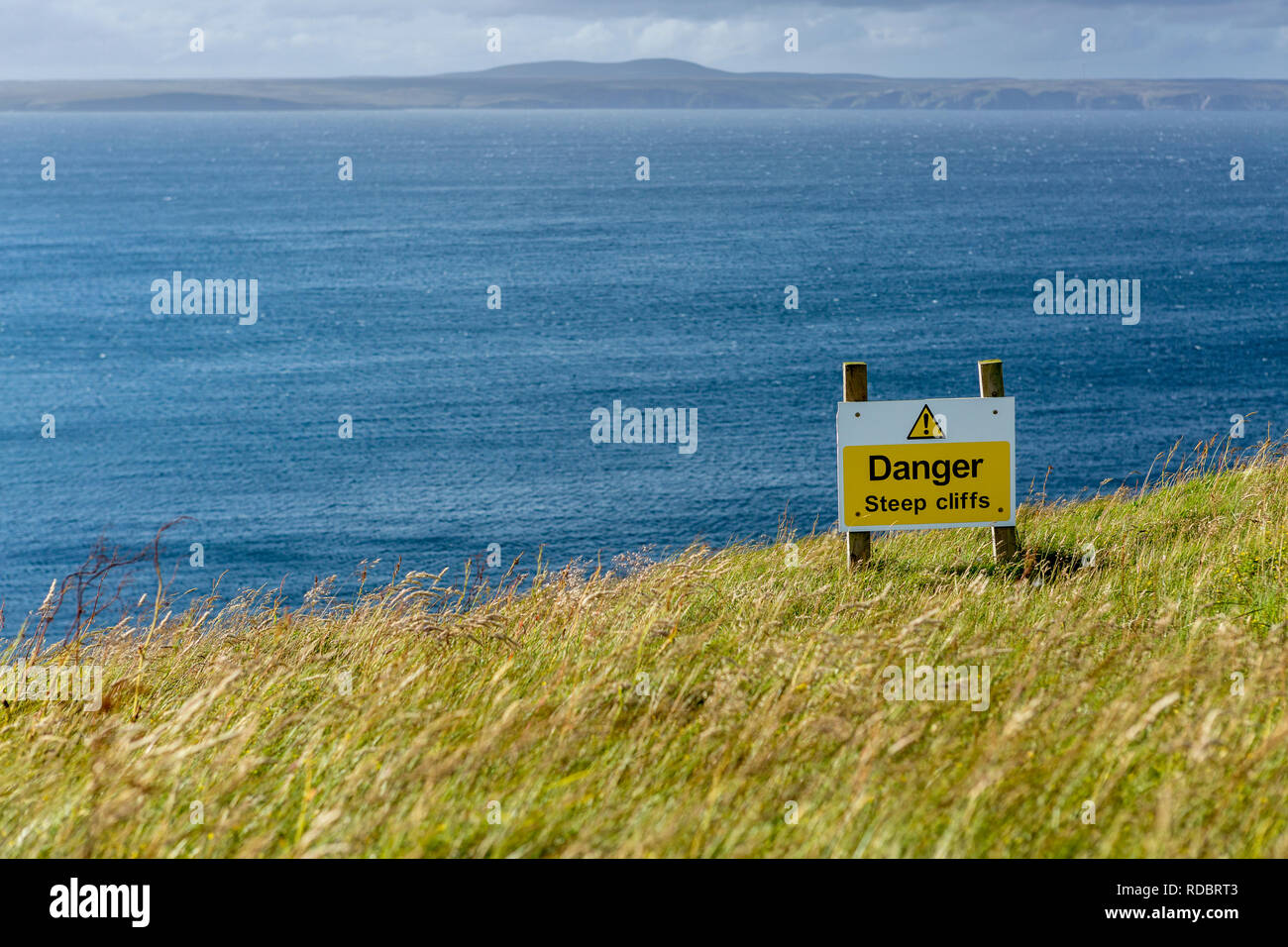 Danger sign on steep cliff by the Atlantic Ocean, Isle of Lewis, Outer ...