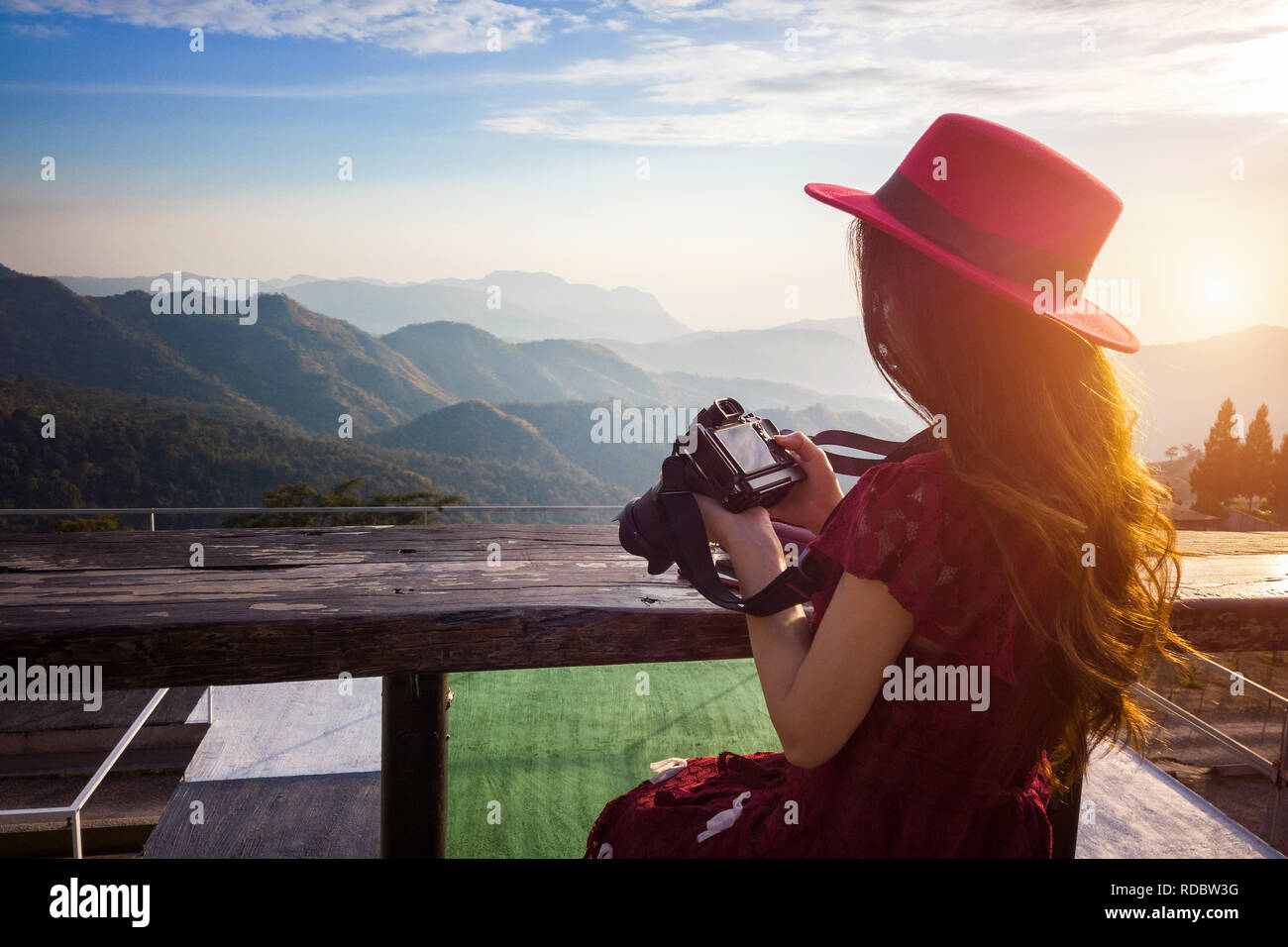 Woman viewing photos on camera Stock Photo - Alamy