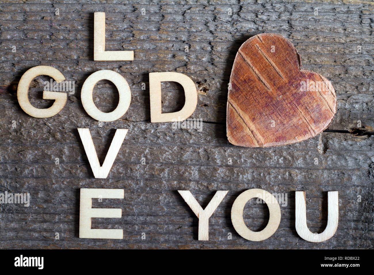 God is love letters with cross and heart religion concept on wooden ...