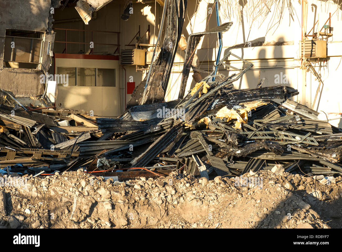 Pile of twisted and broken metal from a demolished factory background ...