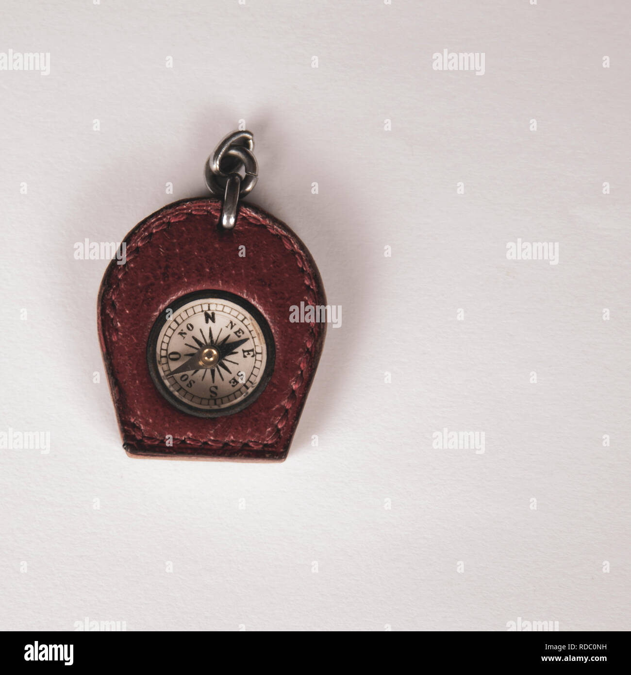 A vintage style compass in red leather on a white background Stock ...