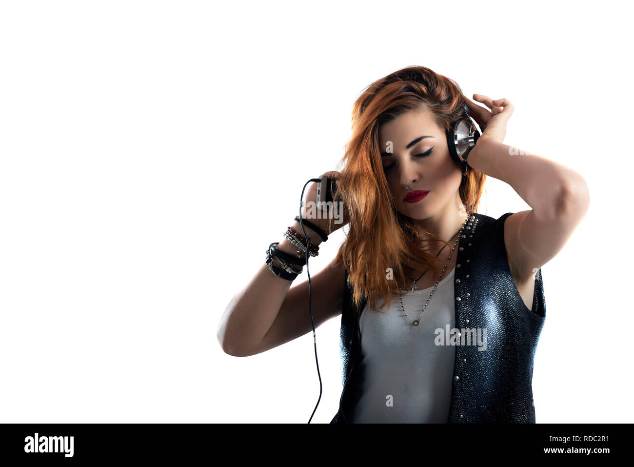 Dancing girl listens to music with headset. isolated on white ...