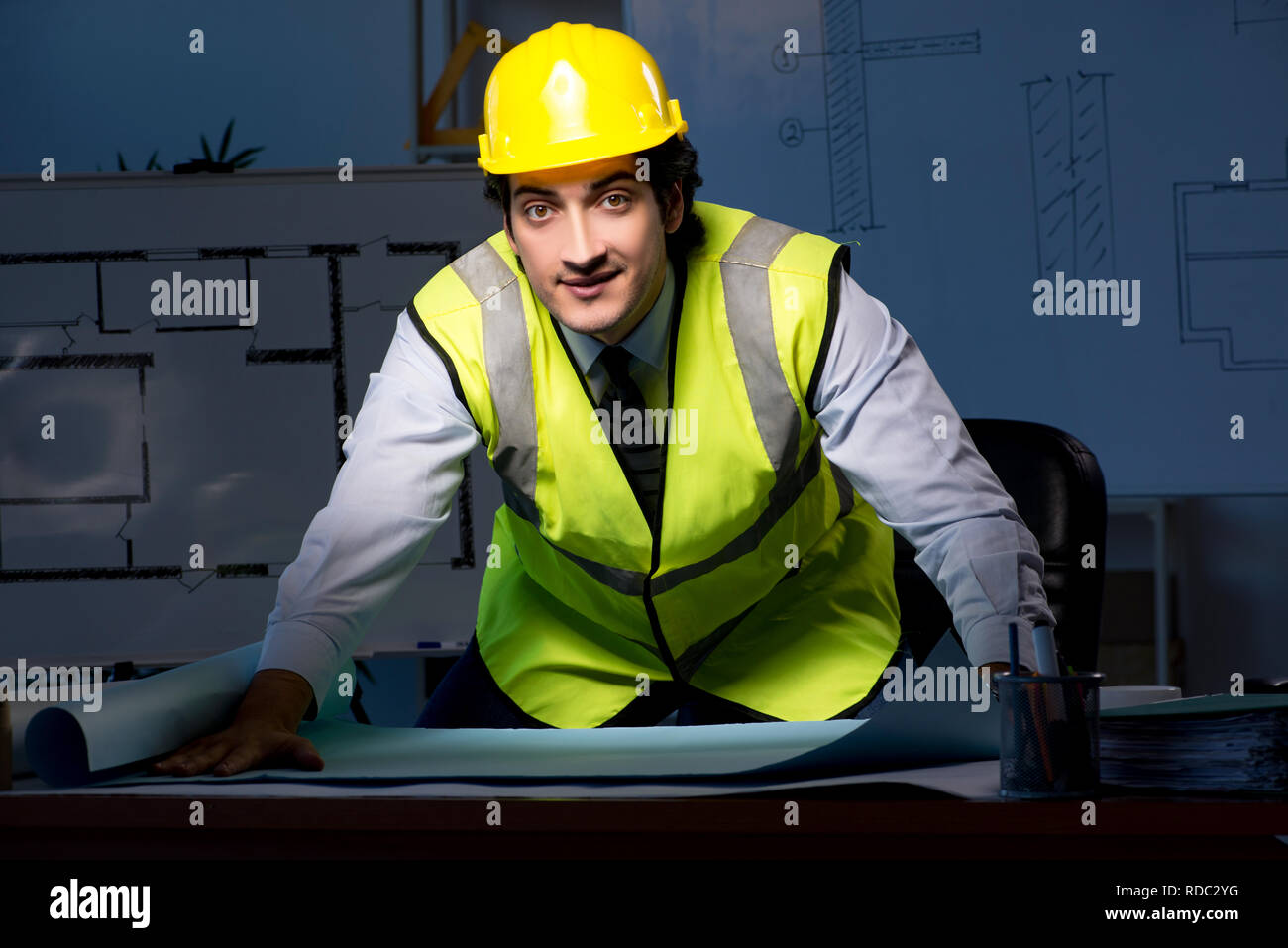 Young construction architect working on project at night Stock Photo ...