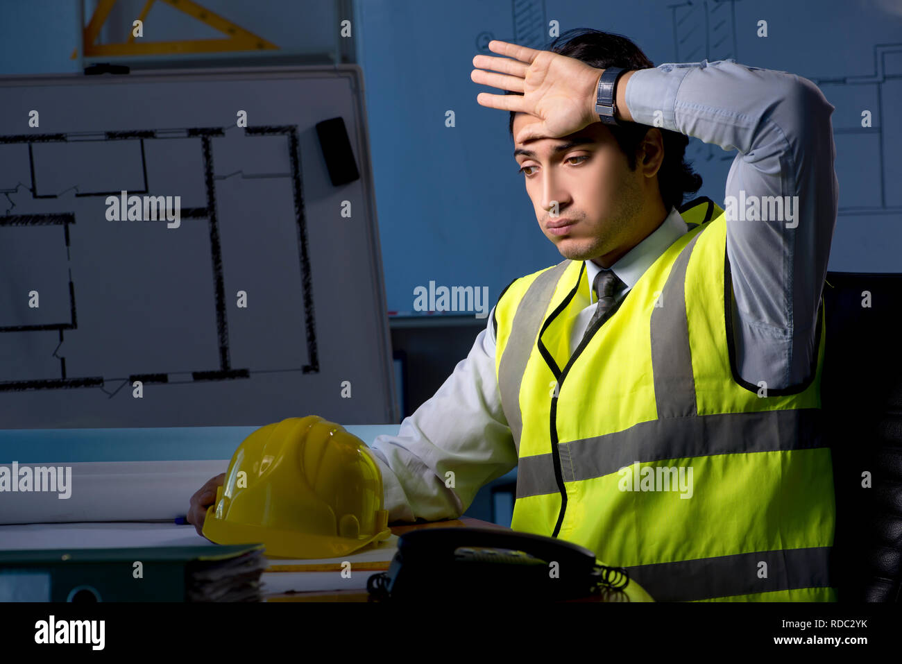 Young construction architect working on project at night Stock Photo ...