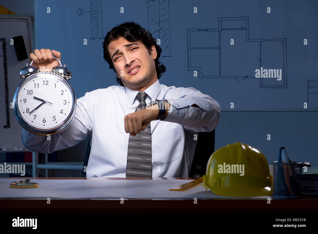 Young construction architect working on project at night Stock Photo ...