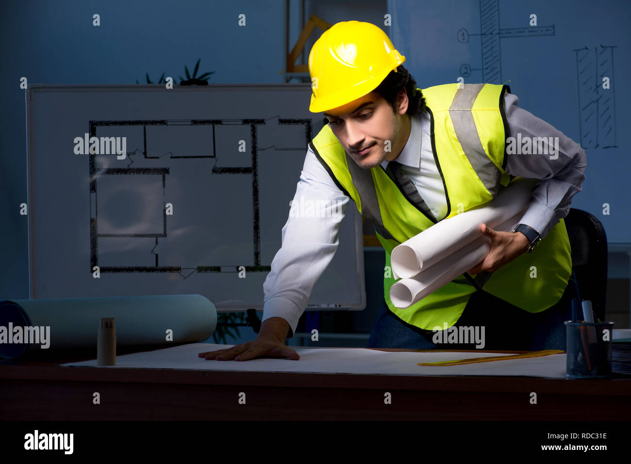 Young construction architect working on project at night Stock Photo ...