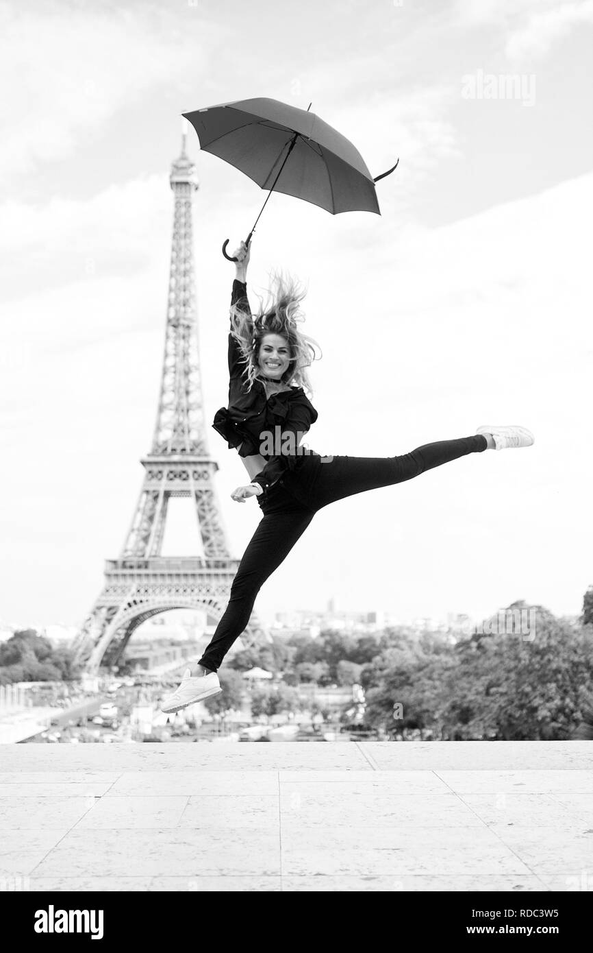 Lady with umbrella excited about visiting Eiffel Tower, sky background ...