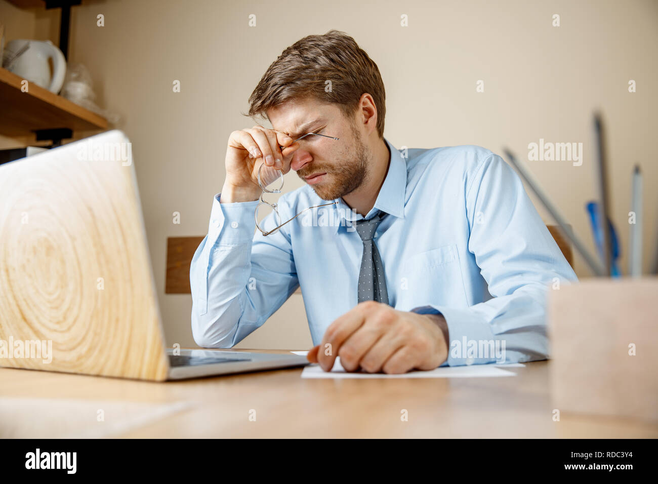 Feeling sick and tired. Frustrated sad unhappy sick young man massaging ...