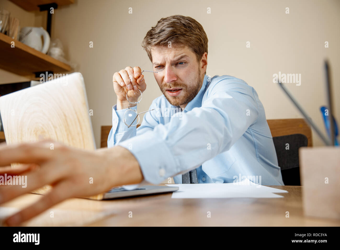 Feeling sick and tired. Frustrated sad unhappy sick young man massaging ...