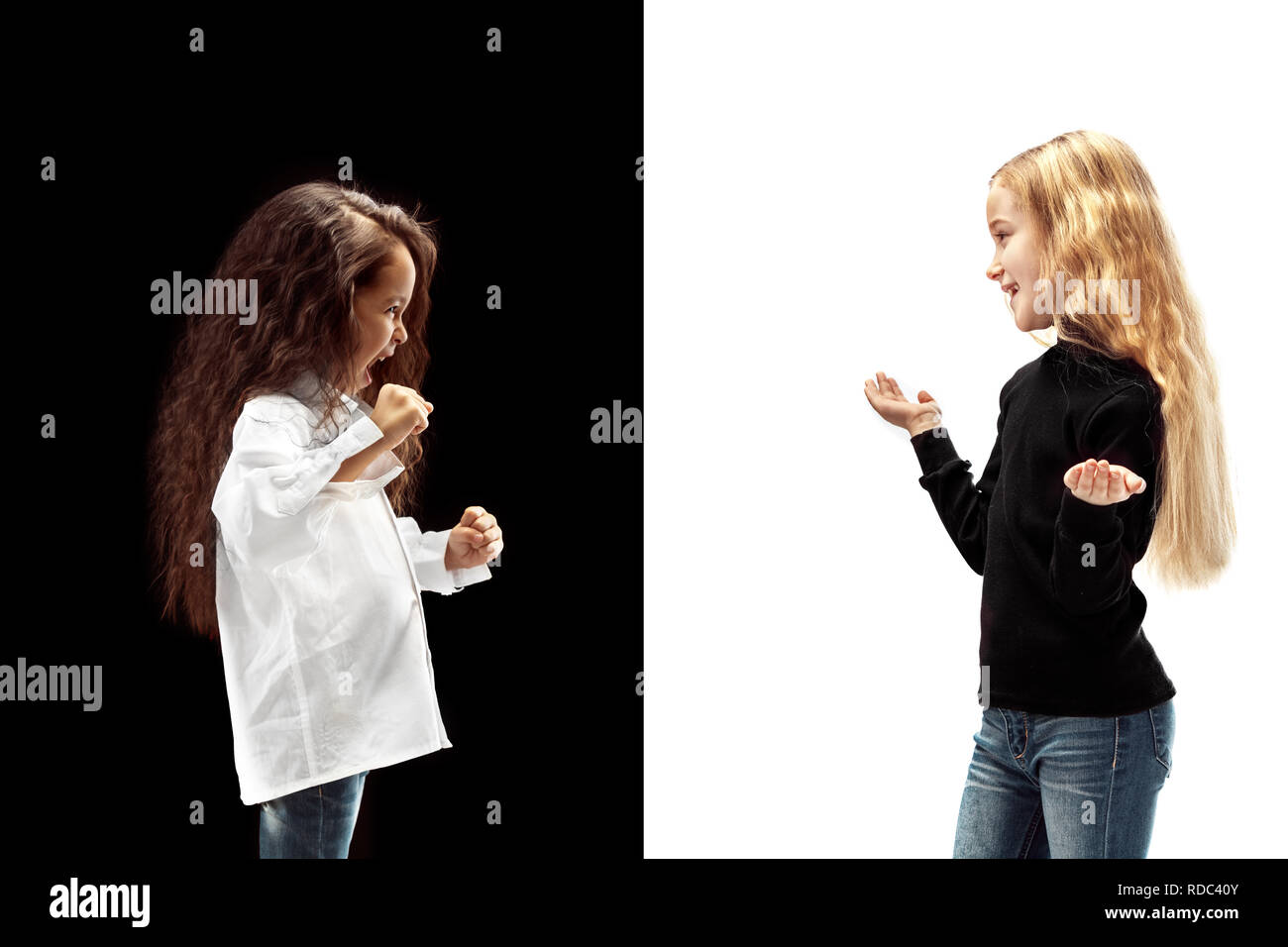 The portrait of emotional happy surprised girl and angry girl on a ... The portrait of emotional happy surprised girl and angry girl on a ...