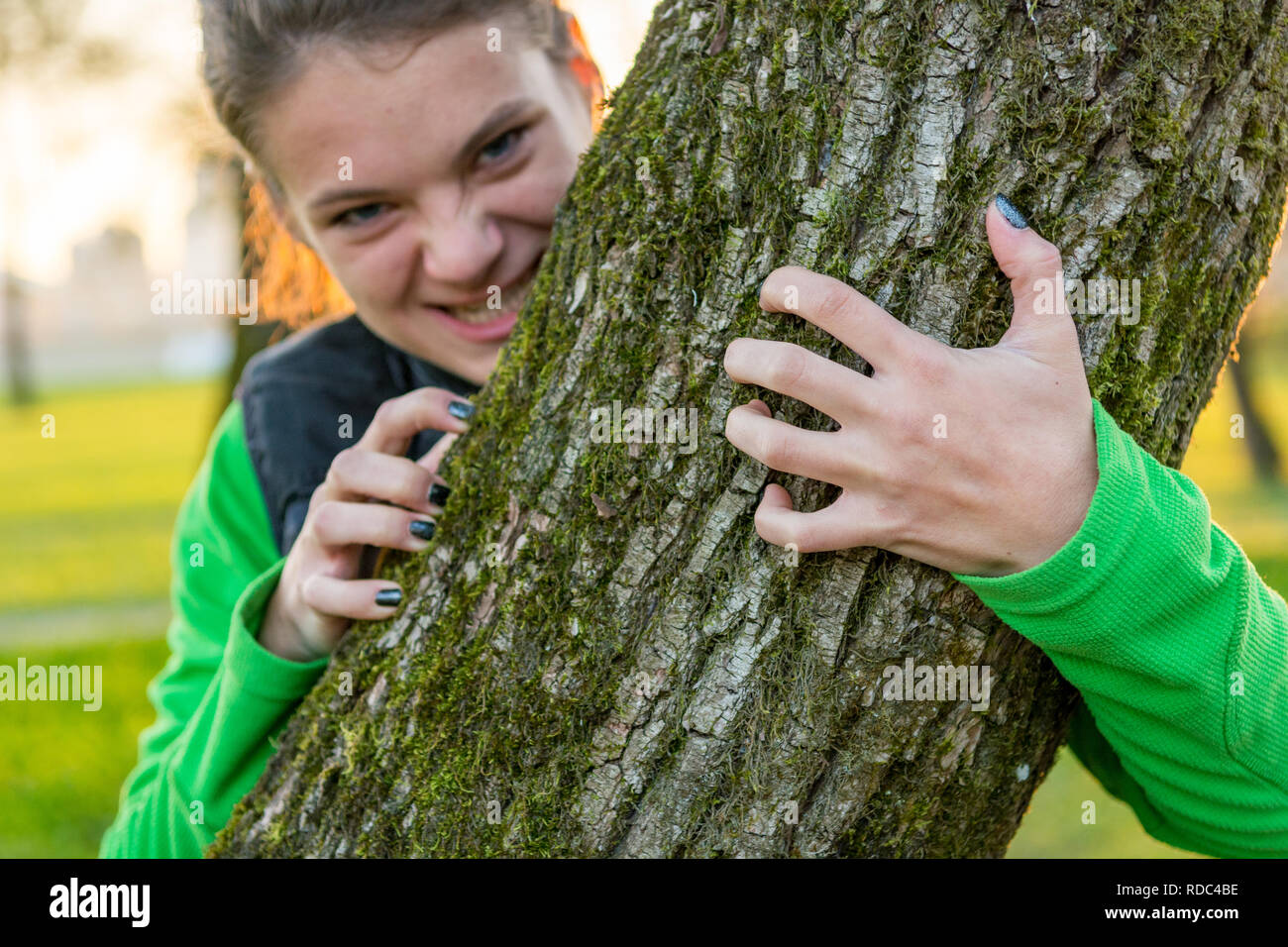 Female clawing at tree trunk raising environmental awareness. Climate ...