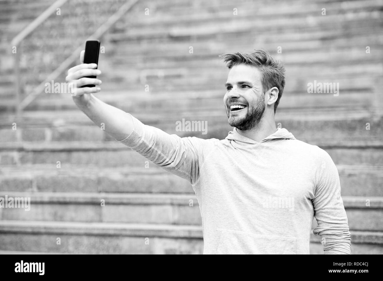 Man With Beard Walks With Smartphone Urban Background With Stairs Man