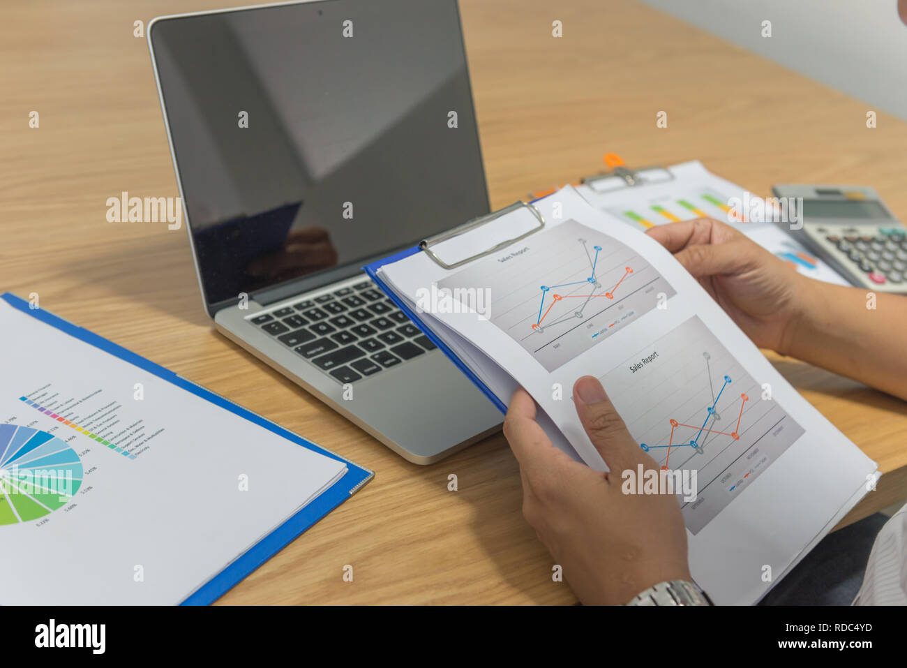 Businessman reading data in chart Stock Photo - Alamy