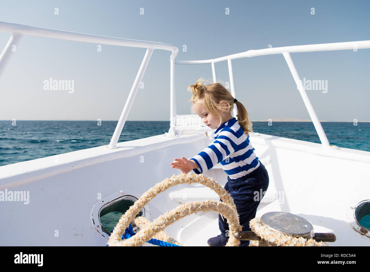 Yachting sport. Child cute sailor help with ropes yacht bow. Adventure ...