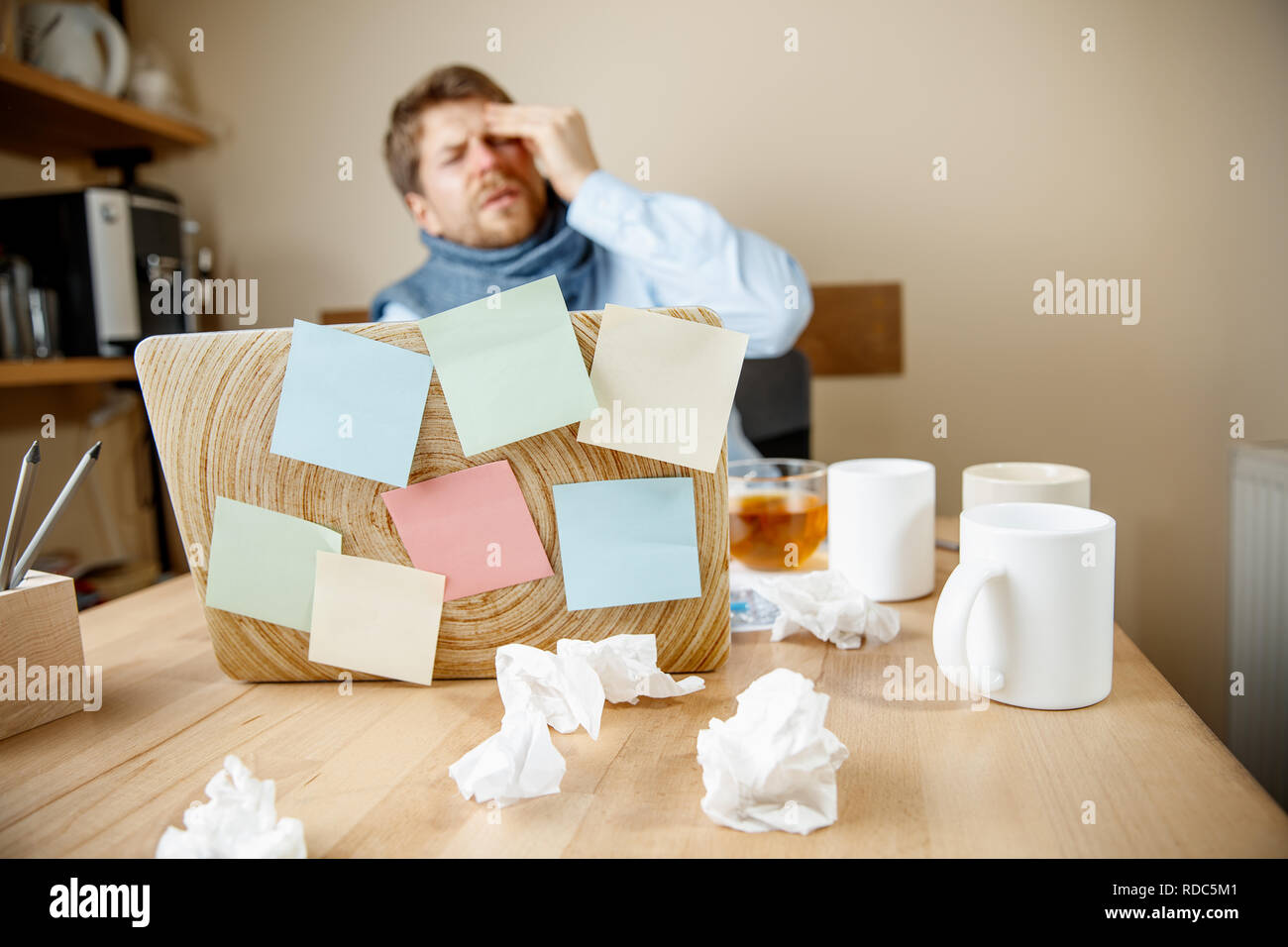 Feeling sick and tired. Frustrated sad unhappy sick young man massaging ...