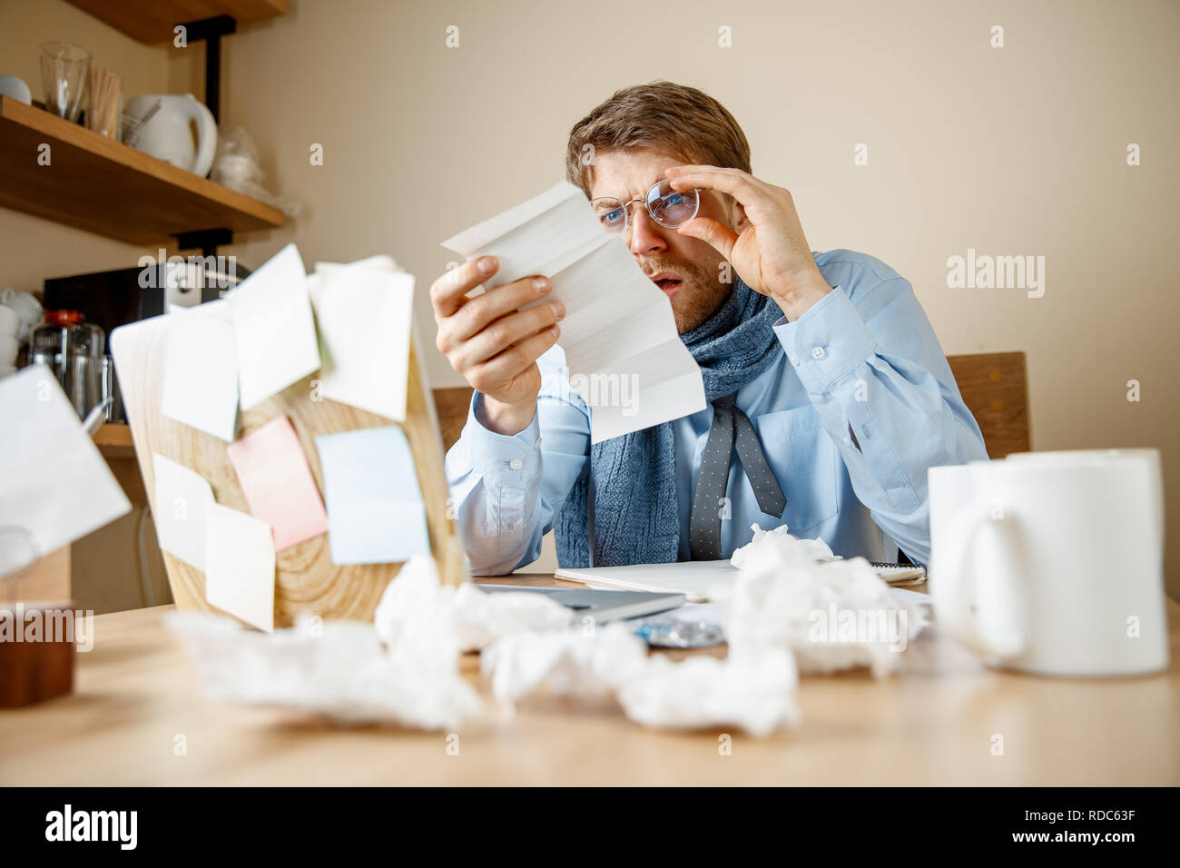 Sick man reading prescription medicine working in office, businessman ...