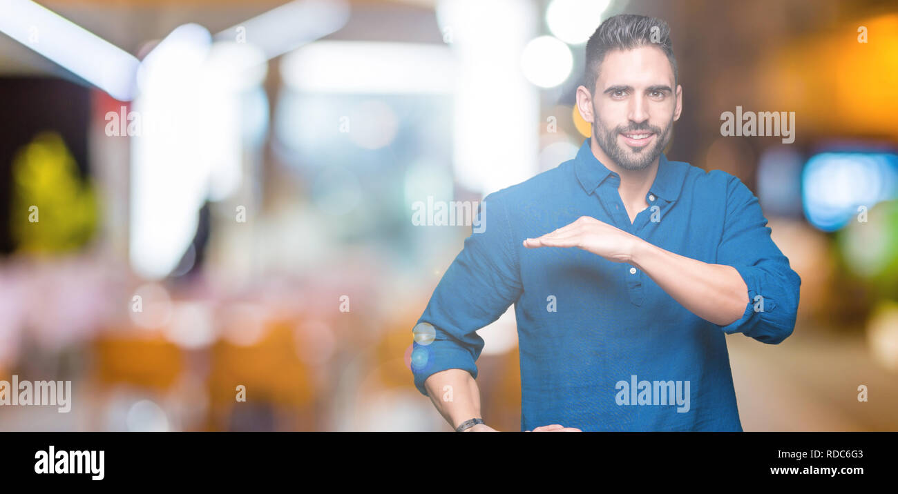 Young handsome man over isolated background gesturing with hands ...