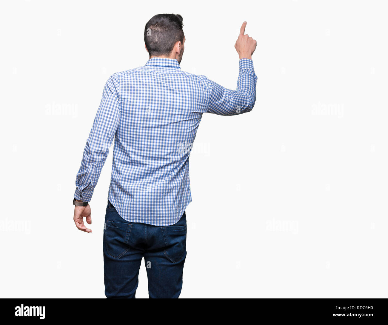 Young handsome man over isolated background Posing backwards pointing ...