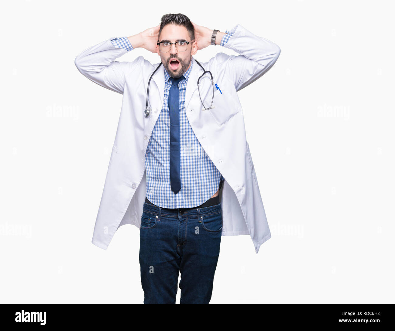 Handsome young doctor man over isolated background Crazy and scared ...