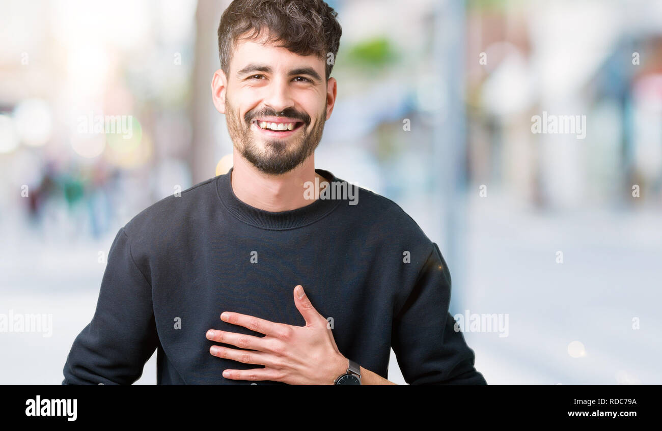 Young handsome man over isolated background Smiling and laughing hard ...
