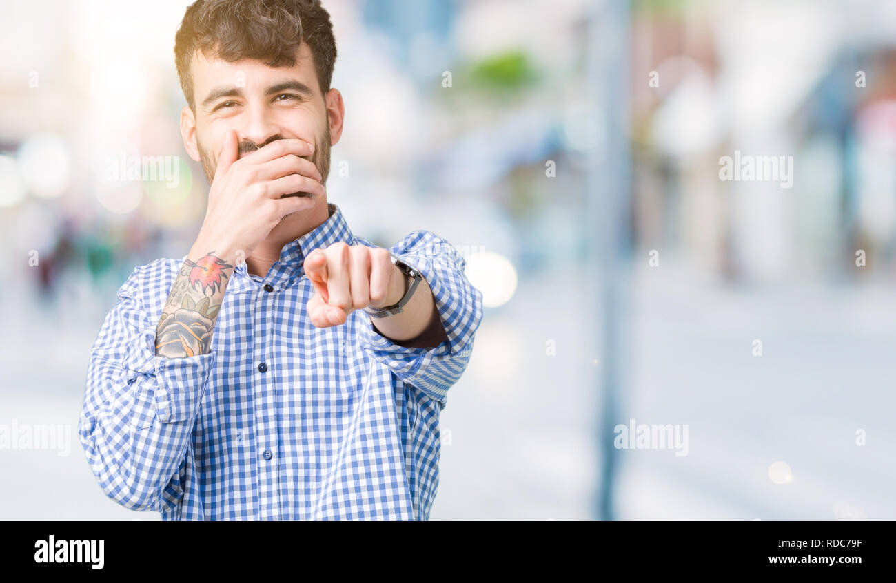 Man hand over mouth laughing hi-res stock photography and images - Alamy