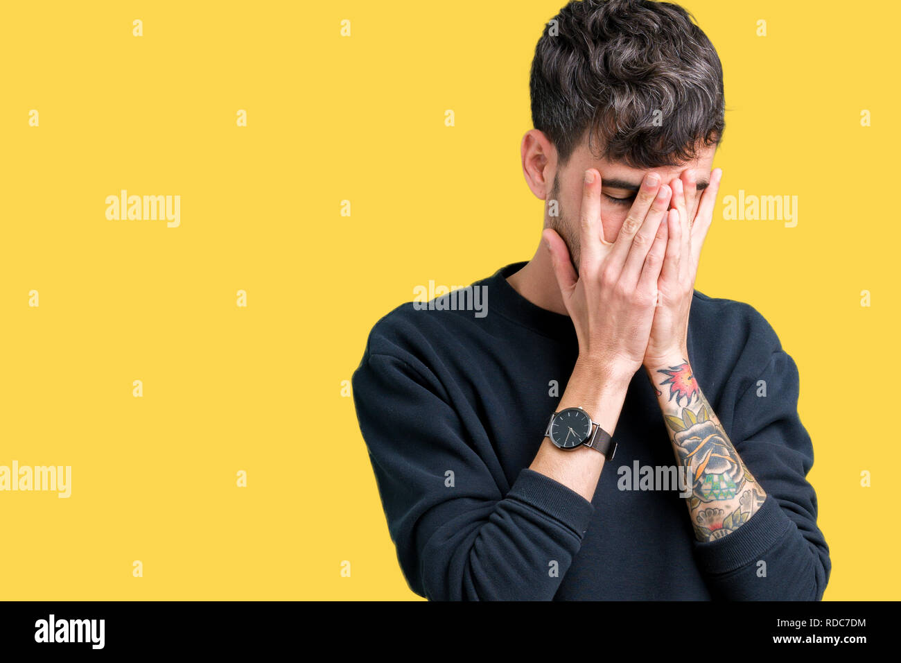 Young handsome man over isolated background with sad expression ...