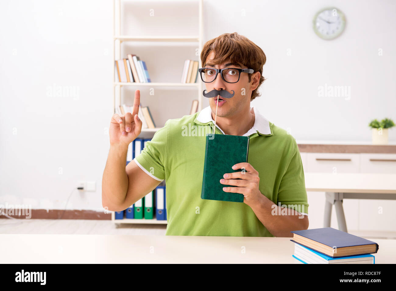 Student with fake moustache reading book Stock Photo - Alamy