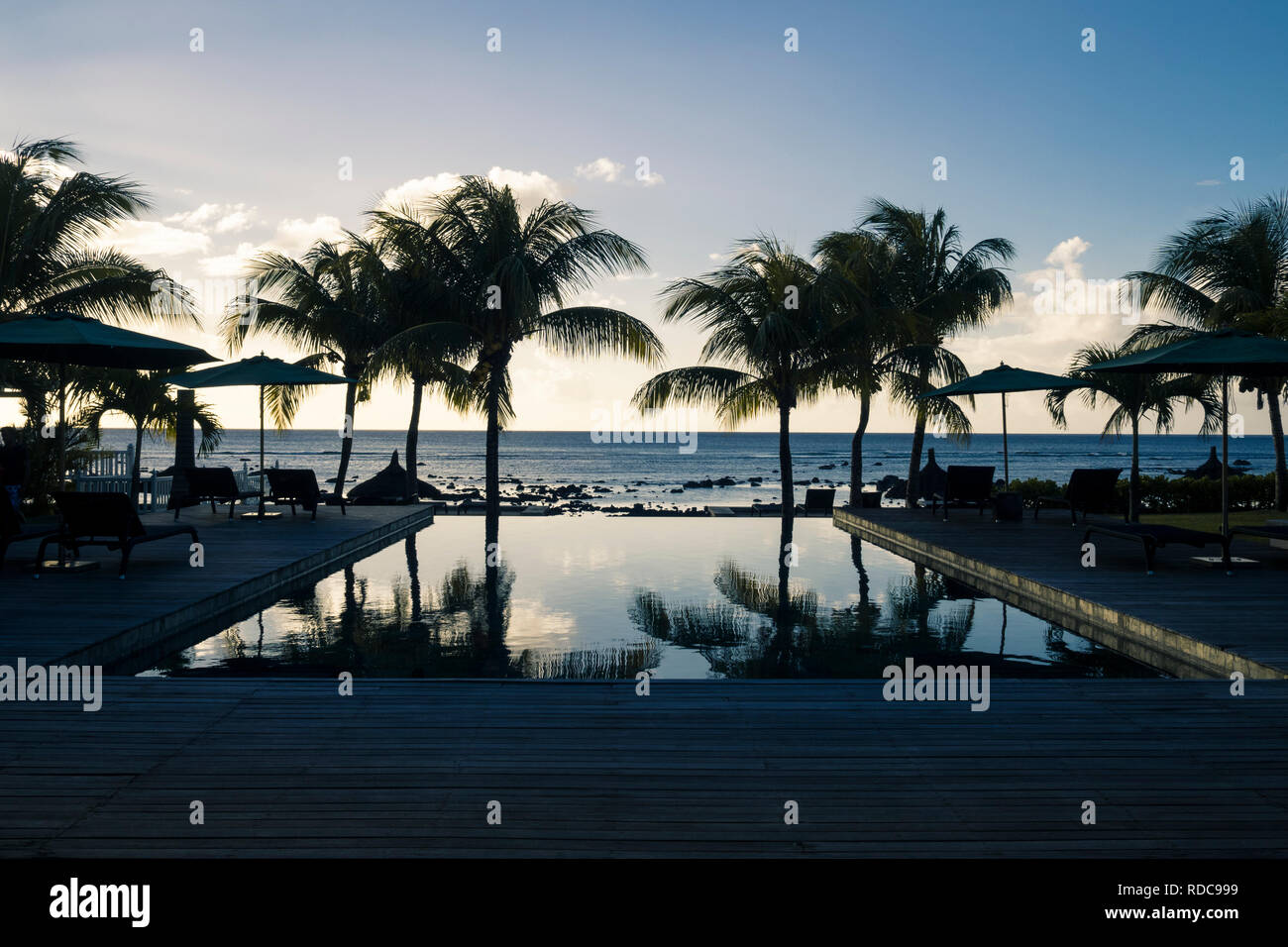 Infinity pool at resort in Mauritius during sunset Stock Photo - Alamy