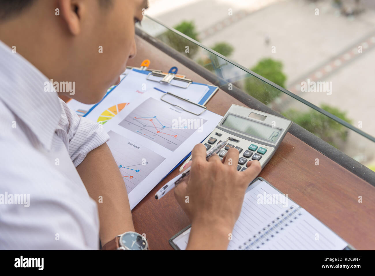 Accountant doing his job, calculate financial documents Stock Photo - Alamy