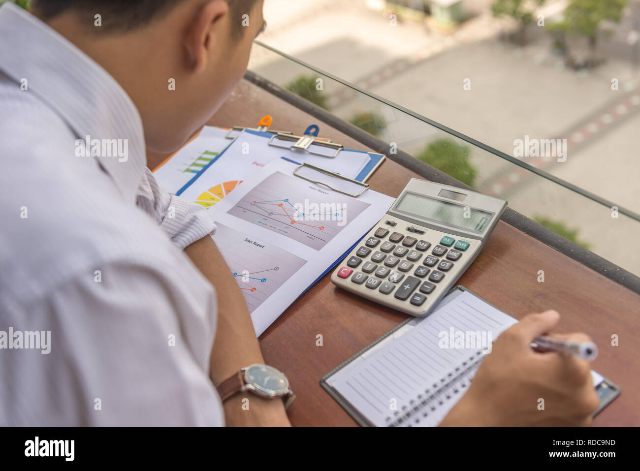 Businessman using calculator financial documents hi-res stock ...