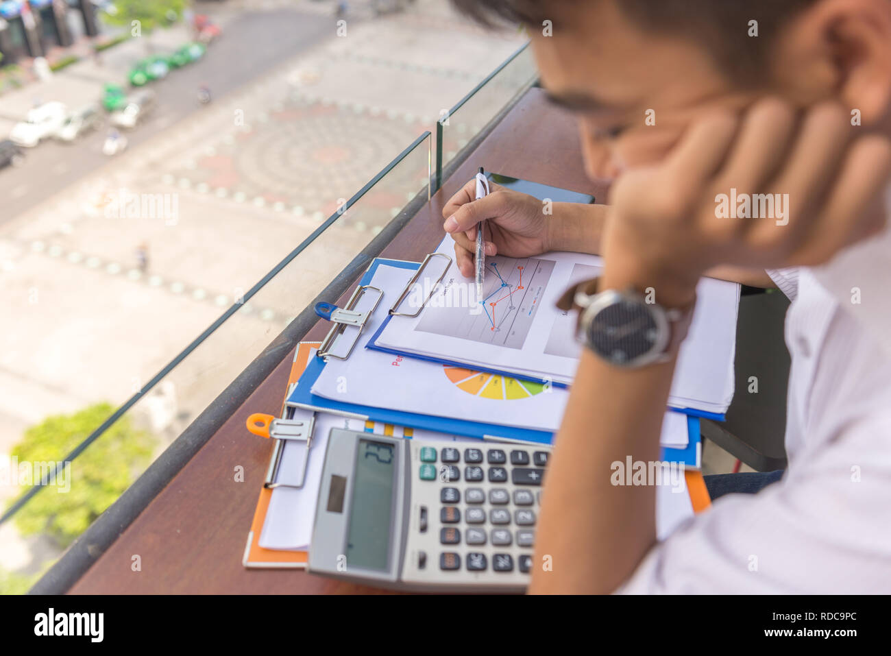 Business employee reading financial report and thinking Stock Photo - Alamy
